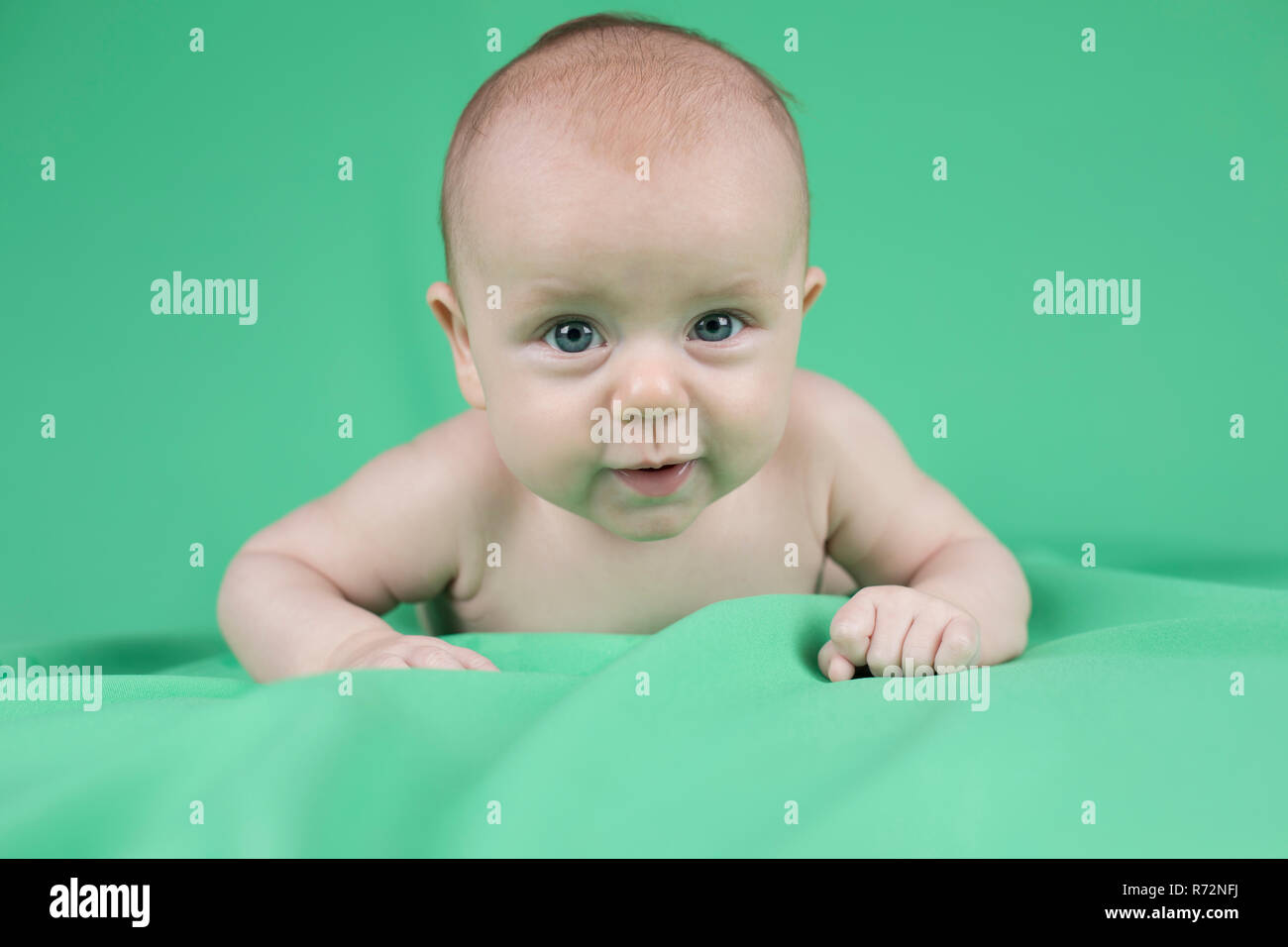Cute happy baby girl crawling Stock Photo - Alamy
