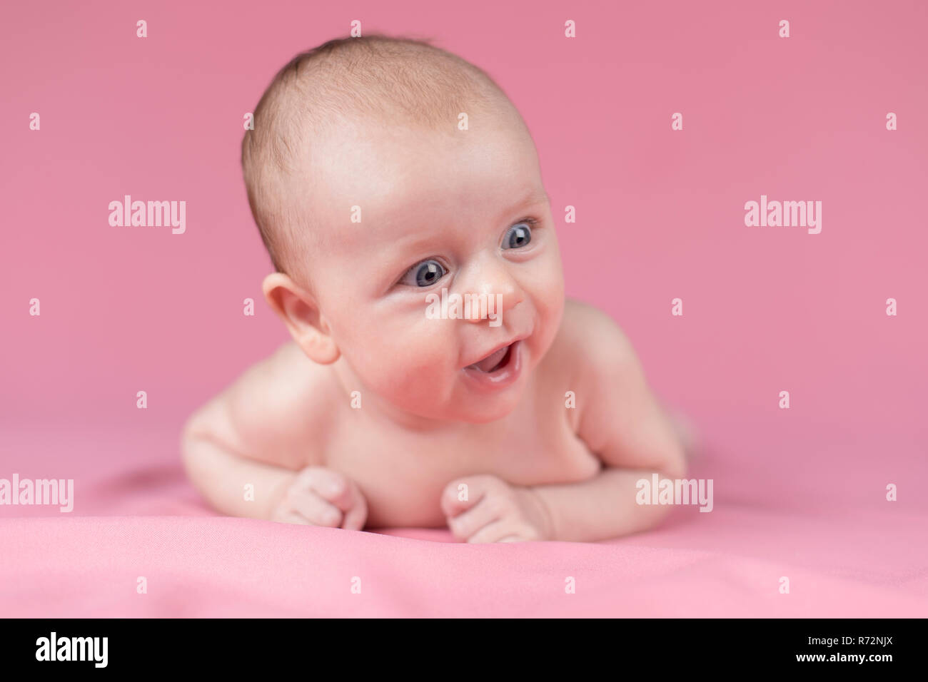 Cute happy baby girl crawling Stock Photo - Alamy