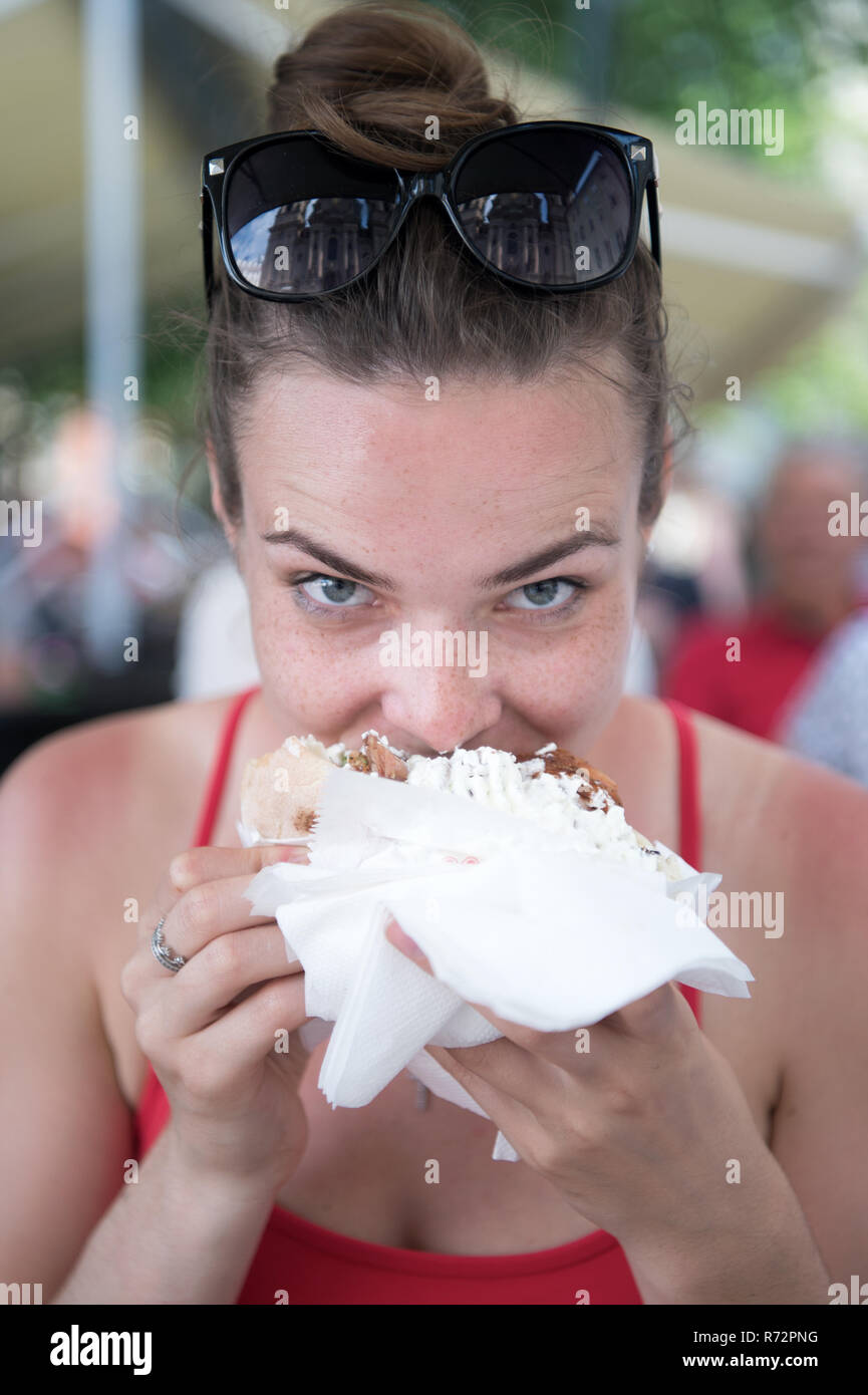 pretty girl or Woman eating sandwich gyros. Girl with pleasure eats ...