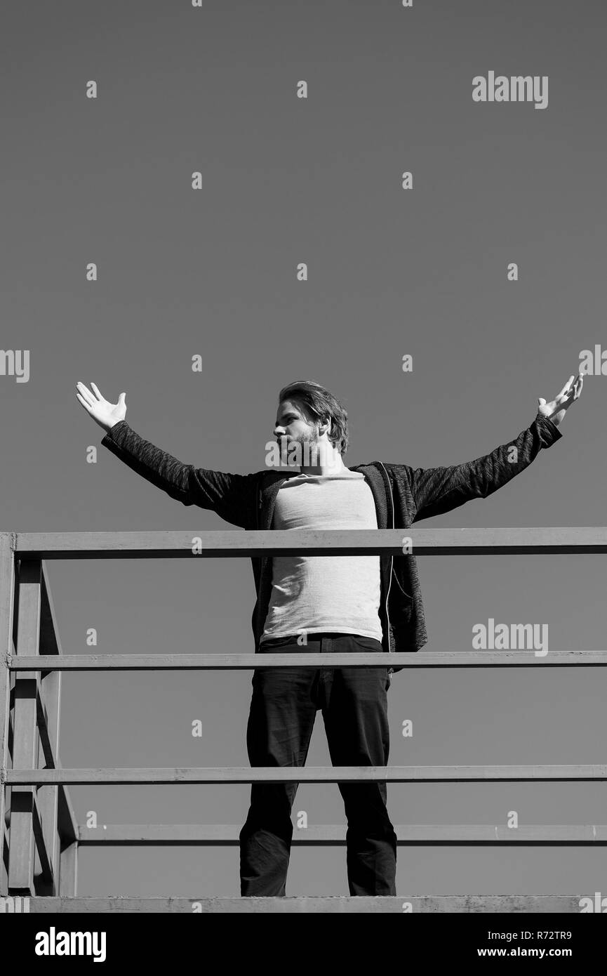 Man with open hand gesture stand on height on sunny blue sky. Freedom ...