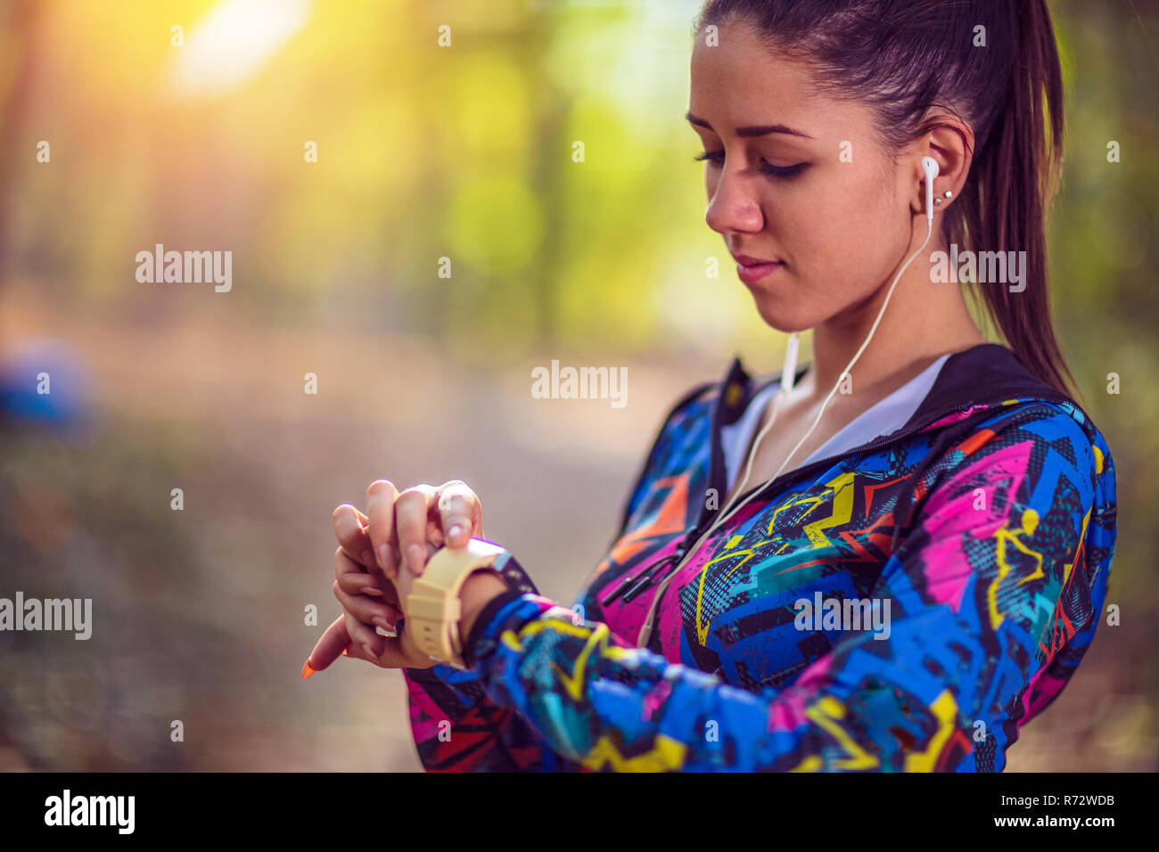 Sport Young Girl jogging g Wearing Smartwatch and Wireless Earphones ...