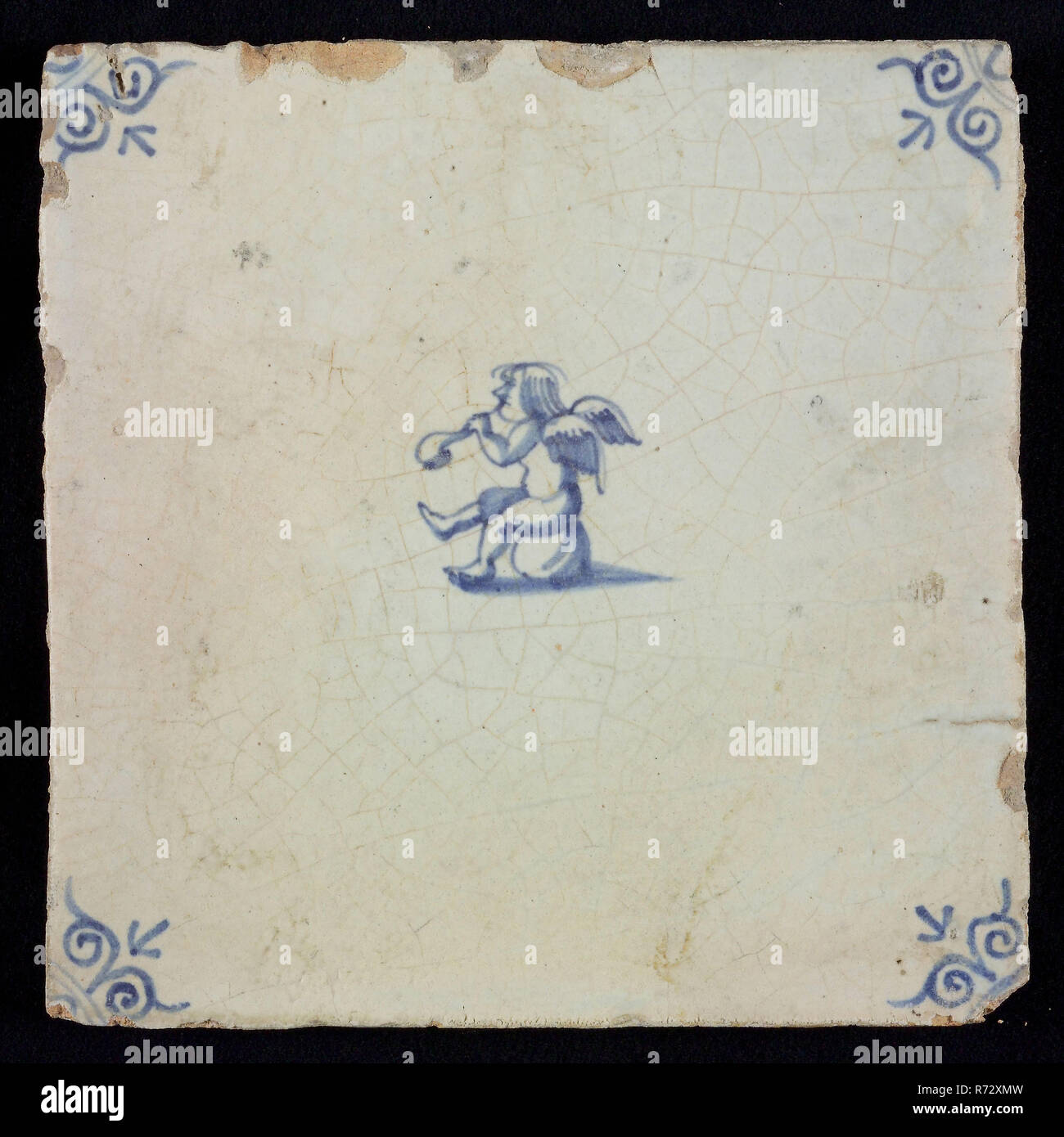 White tile with blue seated putto; corner pattern ox head, wall tile ...