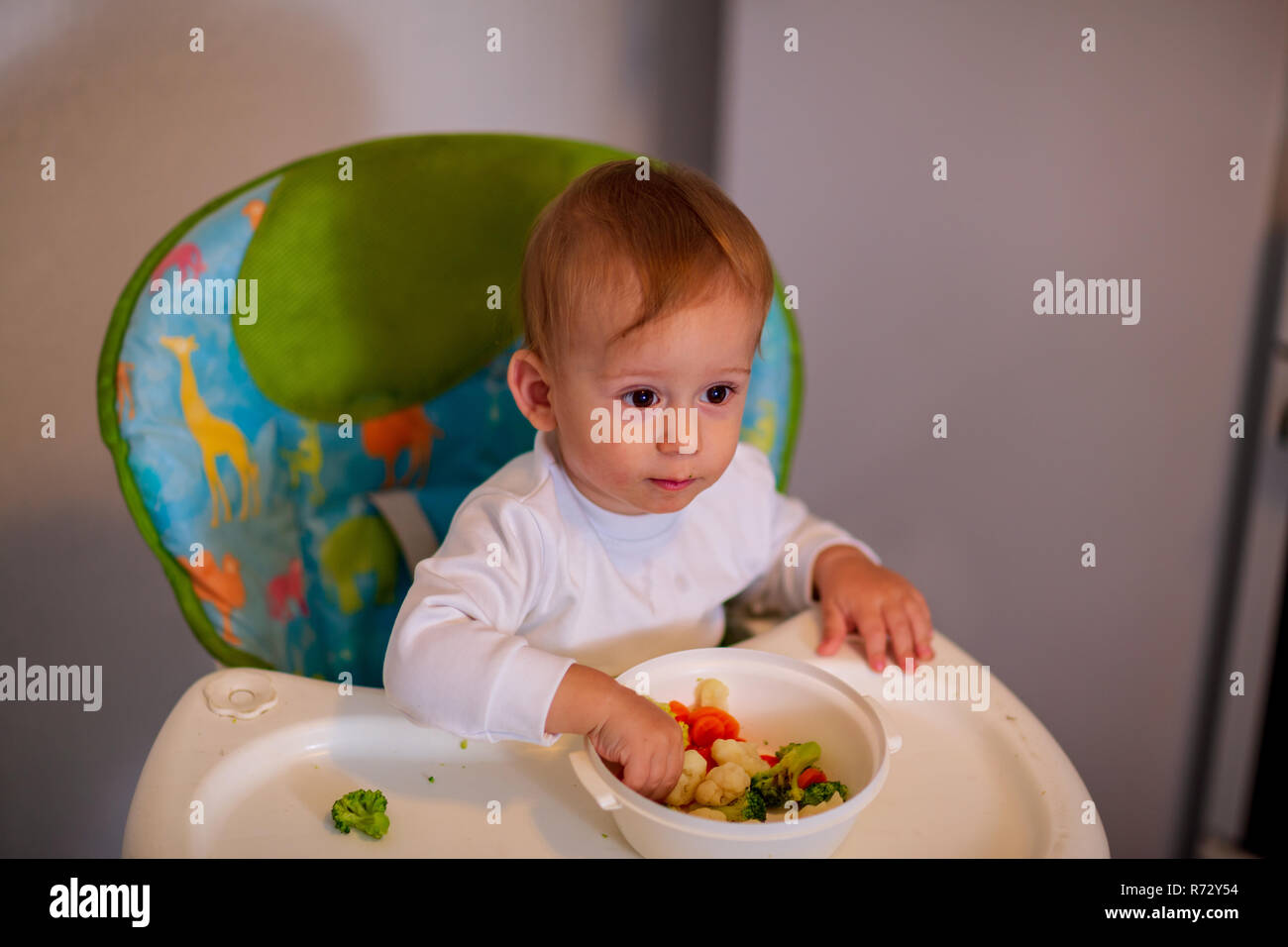 Healthy nutrition for kids. adorable kid boy eating vegetables Stock ...