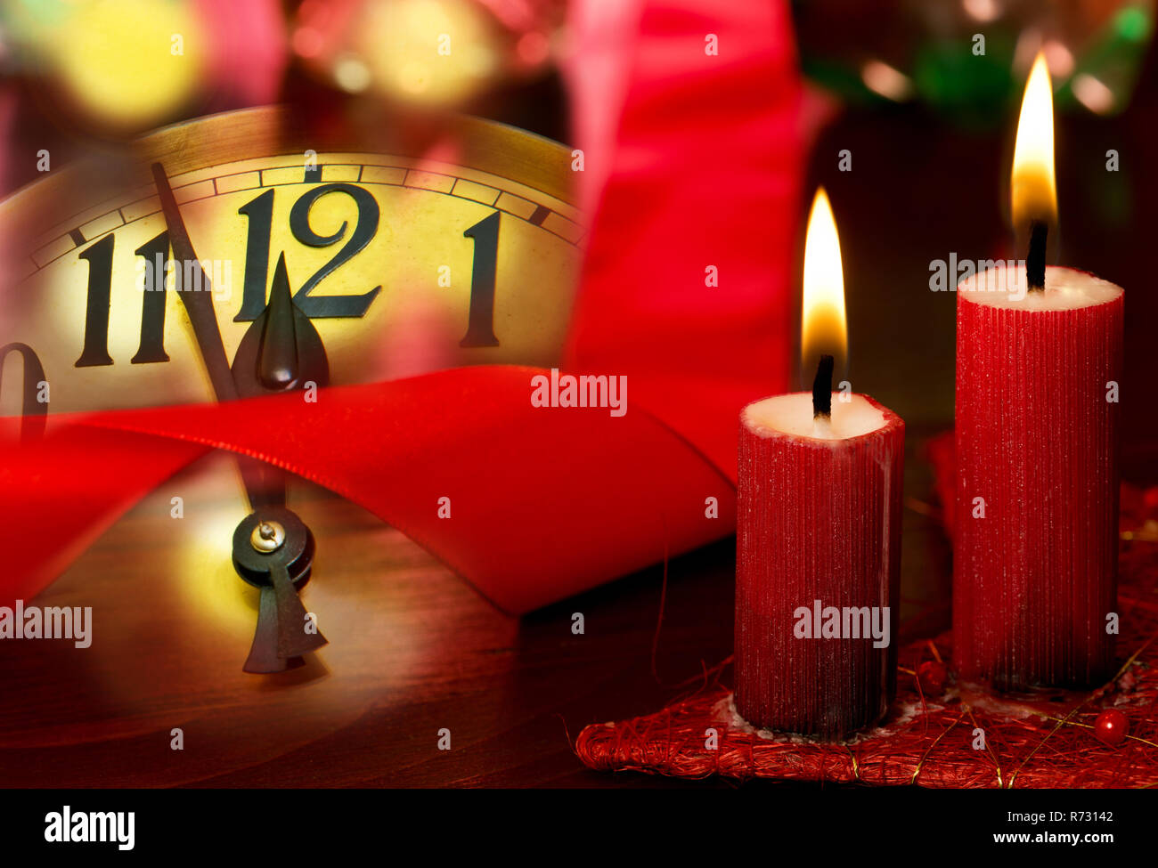 Clock face with candles before midnight Stock Photo - Alamy