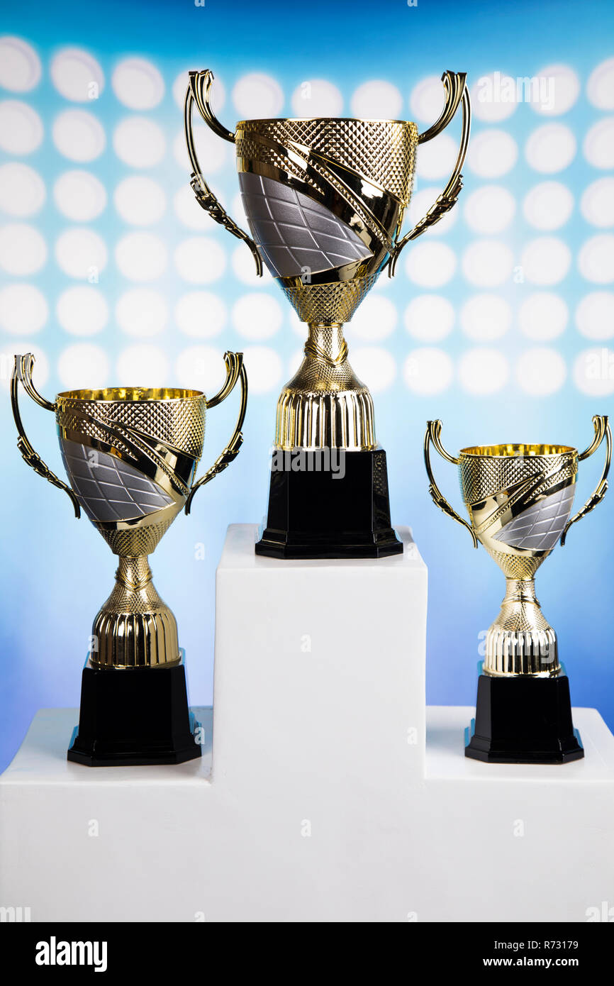 Sport podium, Cups of winners award Stock Photo - Alamy
