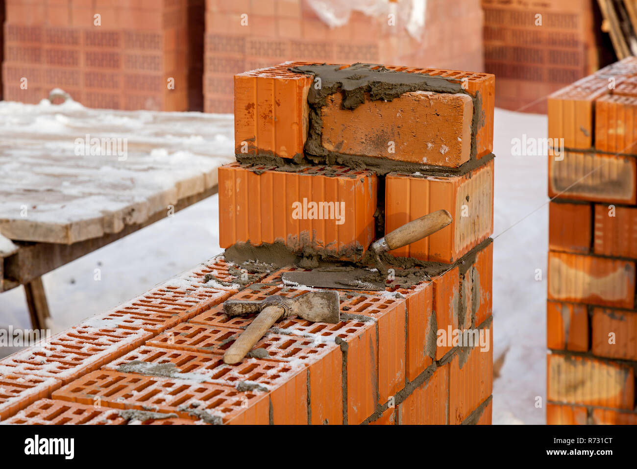 Bricklaying close-up. Brick house from a red brick, construction area ...