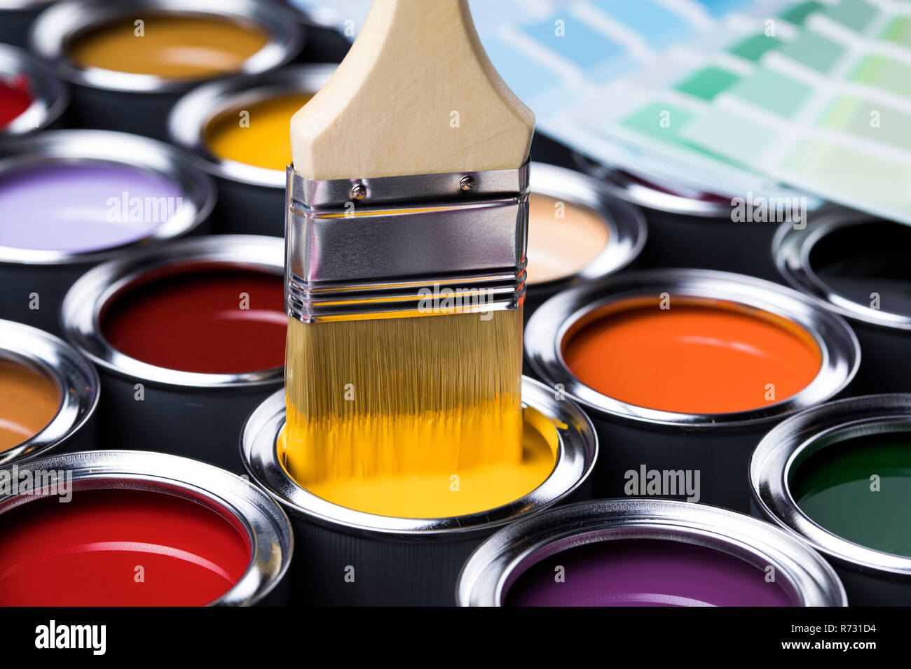 Paint brush, tin can and color guide samples Stock Photo - Alamy
