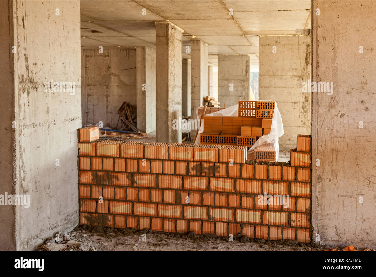 Bricklaying of walls in a high-rise building. Interior and exterior ...