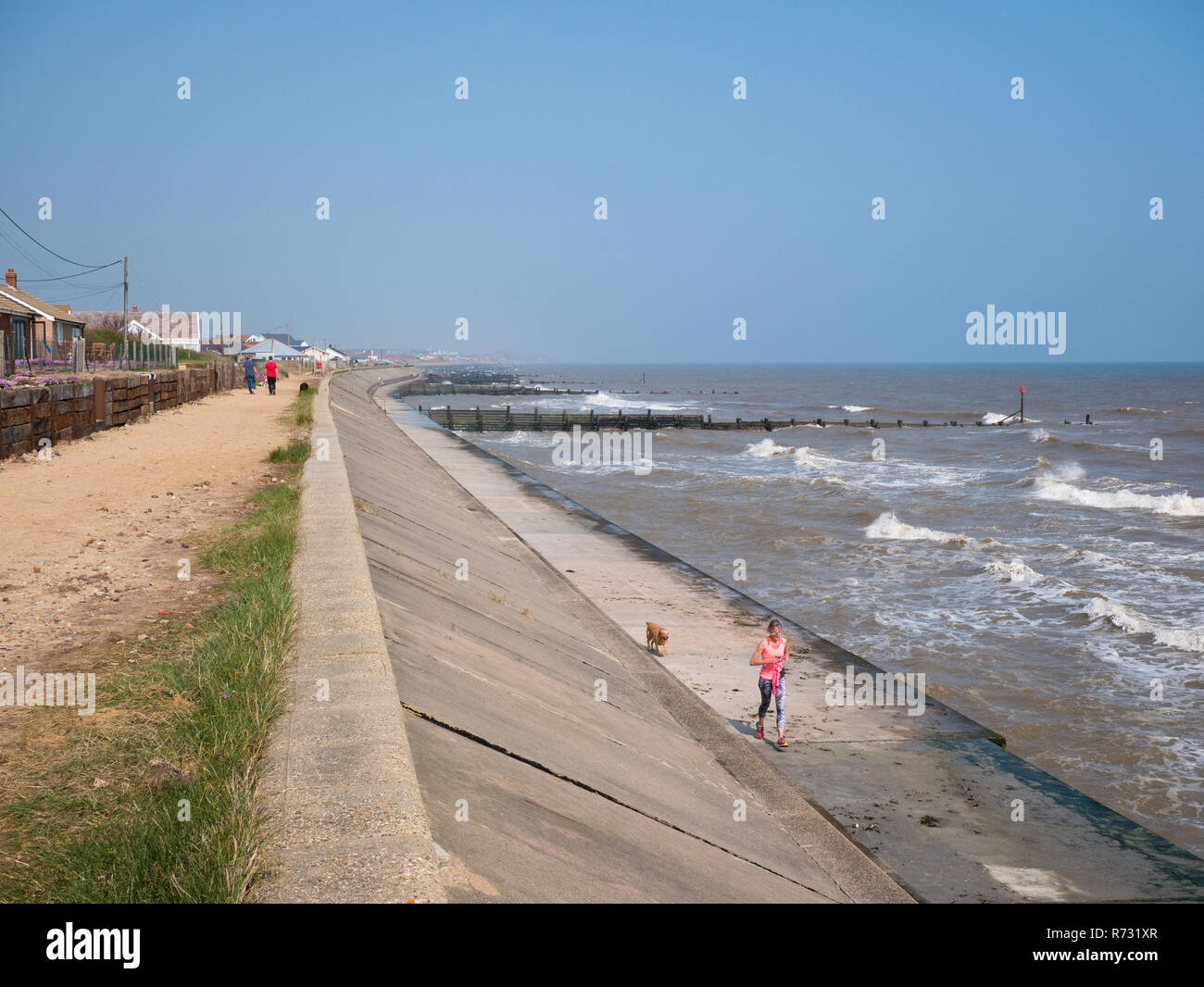 The beach and concrete sea wall at Walcott on the Norfolk coast Stock ...