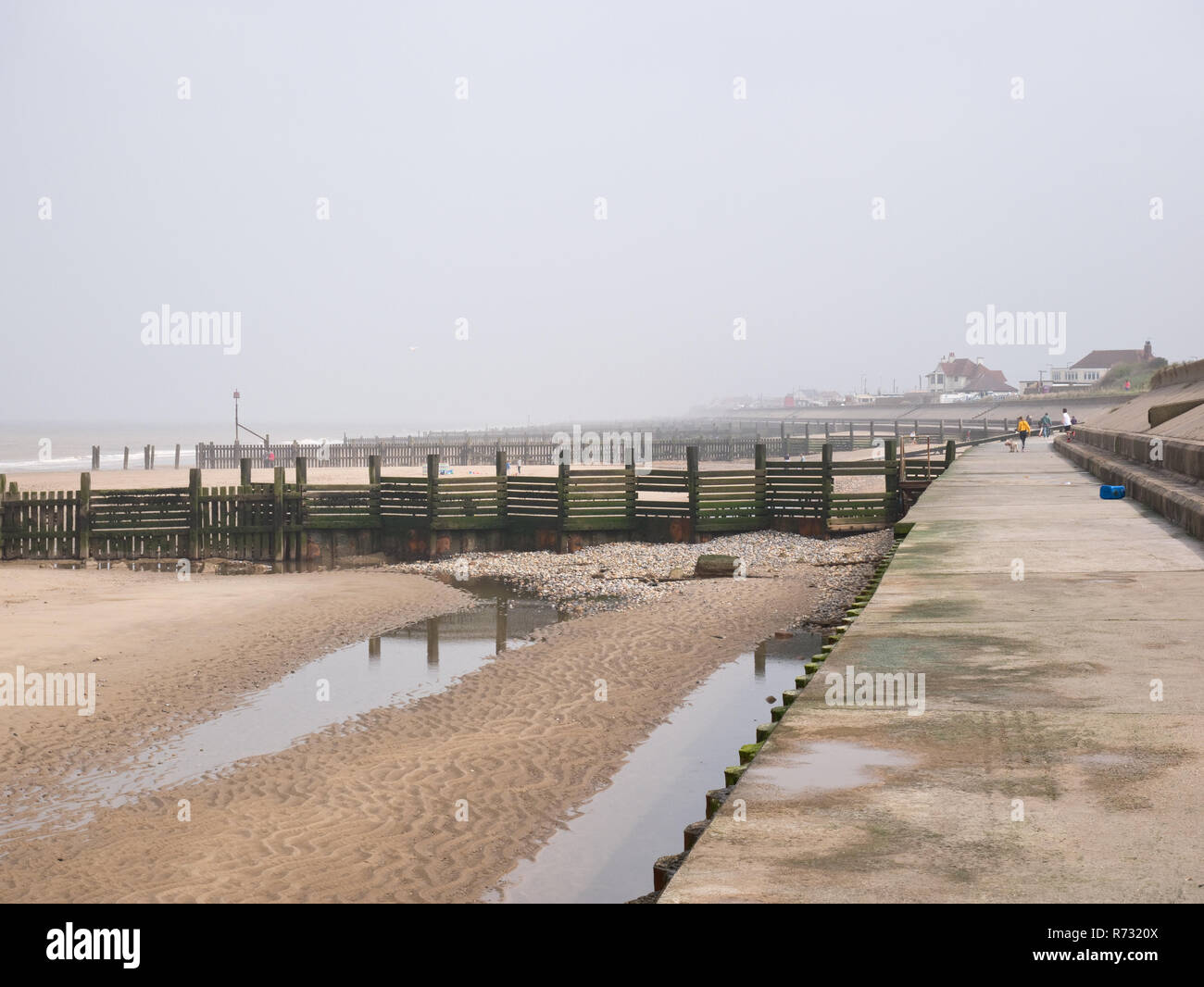 The beach and concrete sea wall at Walcott on the Norfolk coast Stock ...