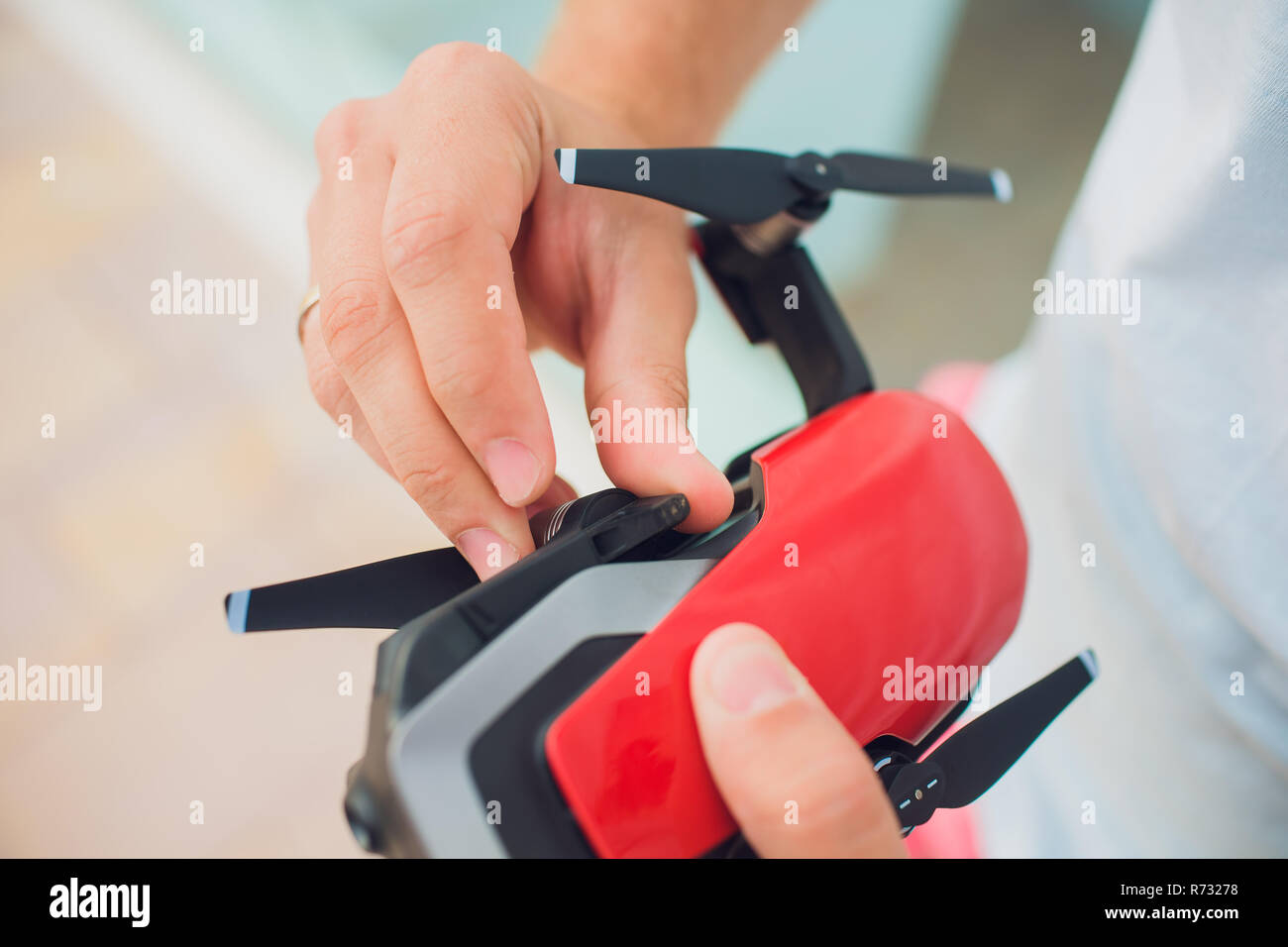 red Drone catching control by man hands lays out propellers Stock Photo ...
