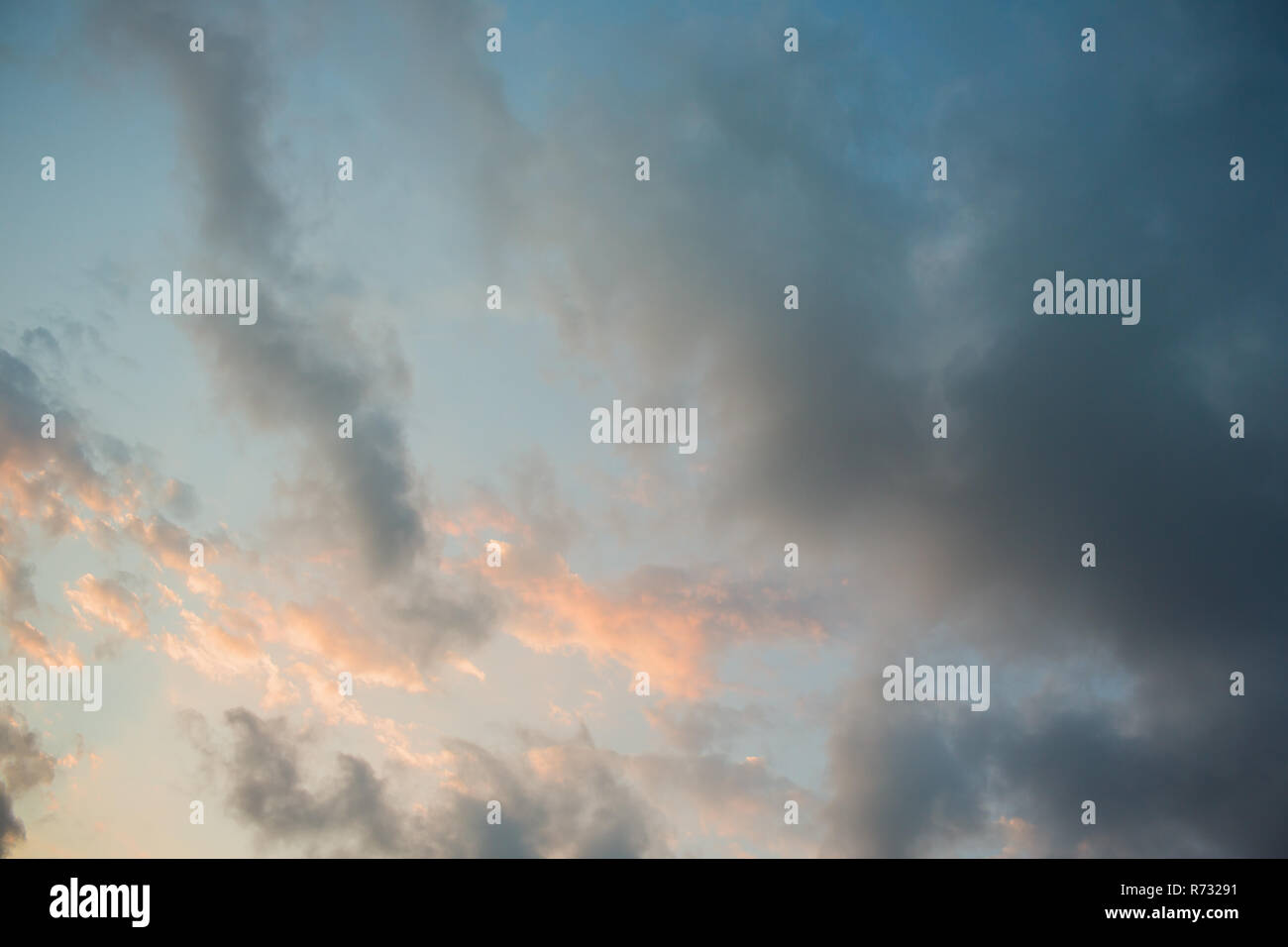 Cumulus sunset clouds with sun setting down Stock Photo - Alamy