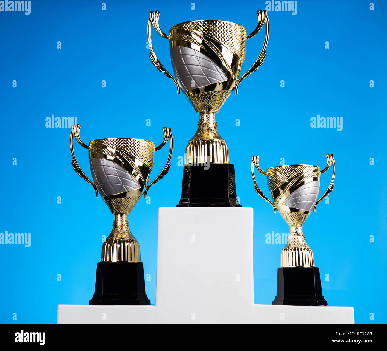 Sport podium, Cups of winners award Stock Photo - Alamy