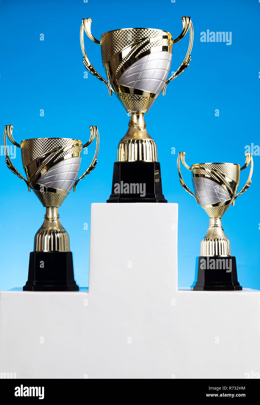 Sport podium, Cups of winners award Stock Photo - Alamy