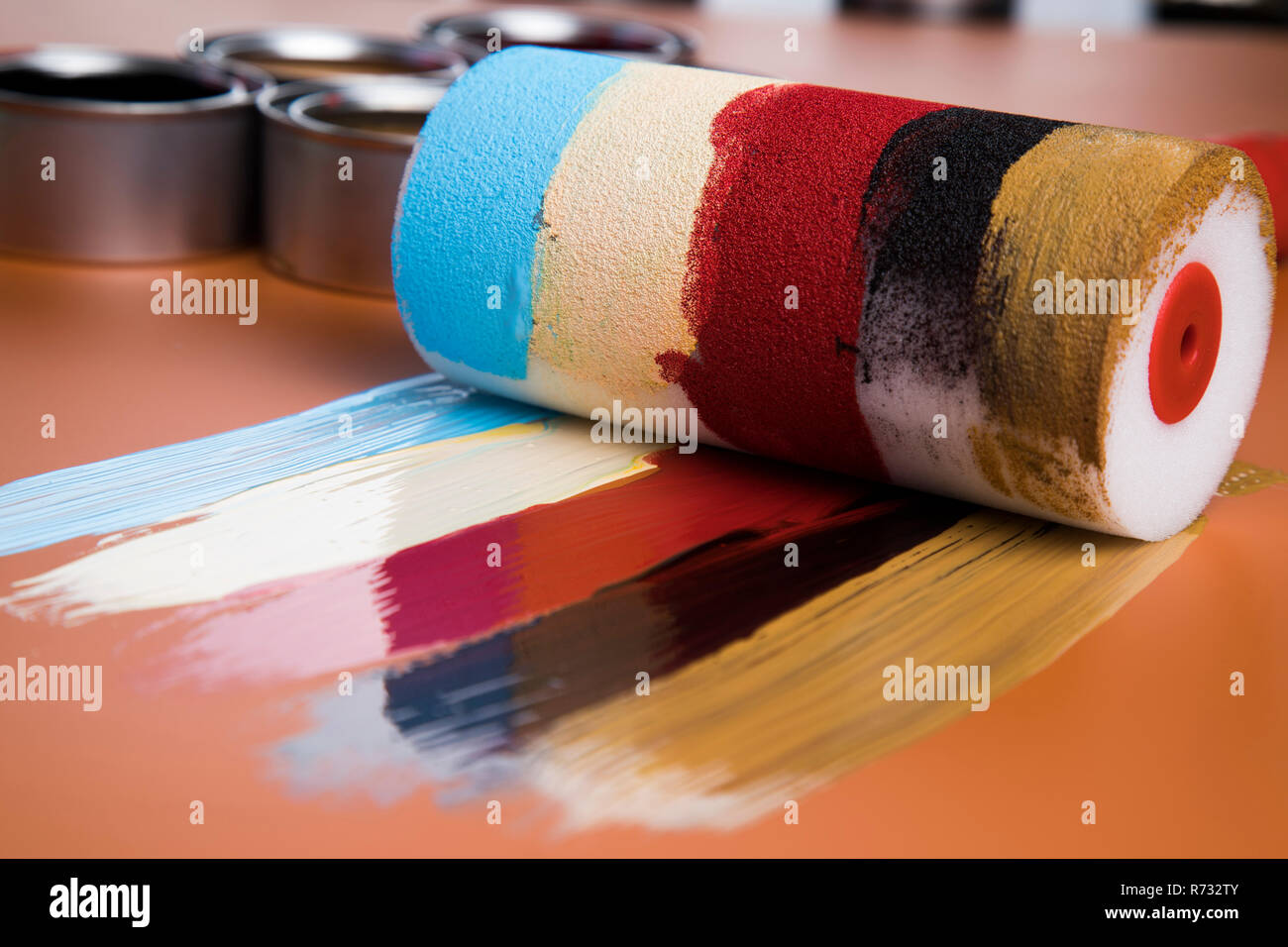 Paint roller, cans with color Stock Photo - Alamy