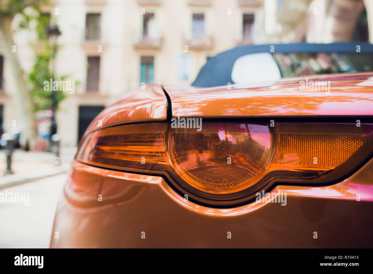 Detail of red metallized orange rear car headlight in eye shape, with ...