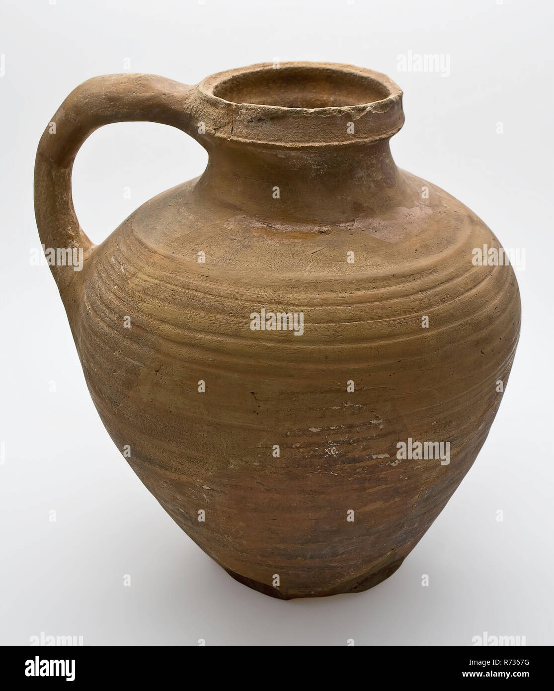 Pottery water jug with ear, on five fins, rings around the belly, water ...