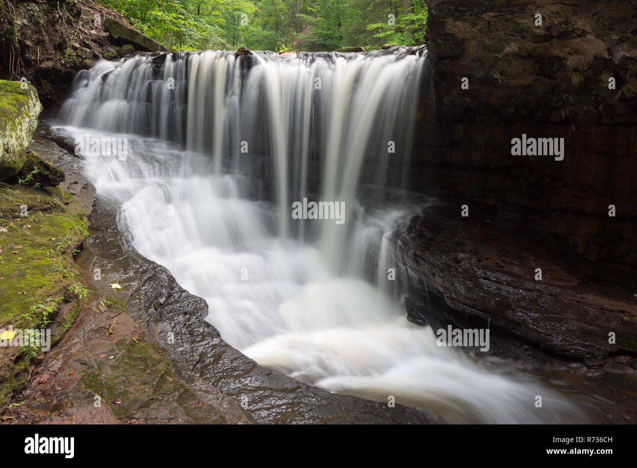 A waterfall pouring over old ruins along Crum Creek. Kennedy Dells ...