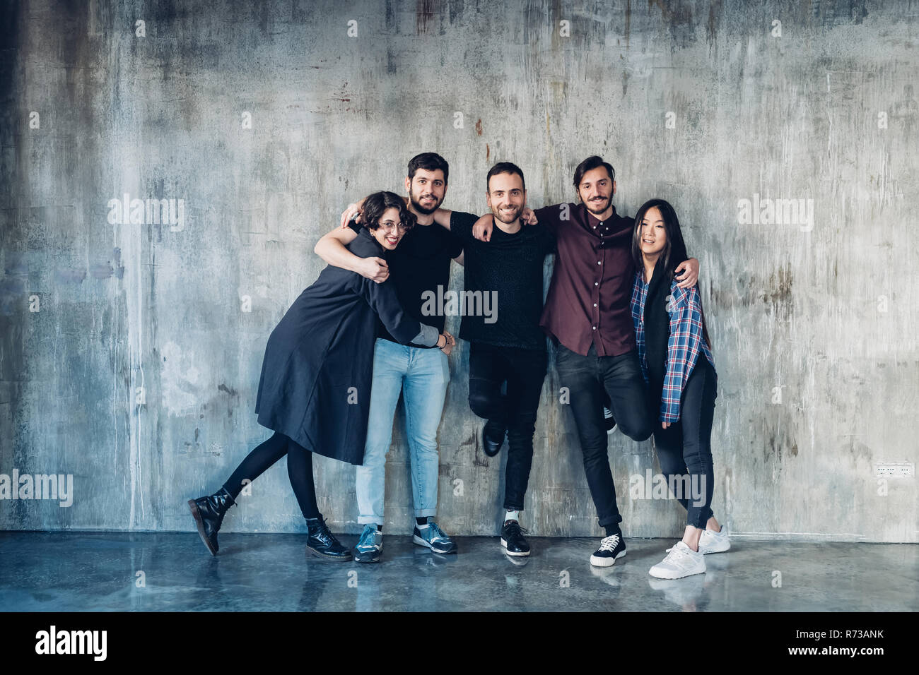 Group of people standing against wall hi-res stock photography and ...