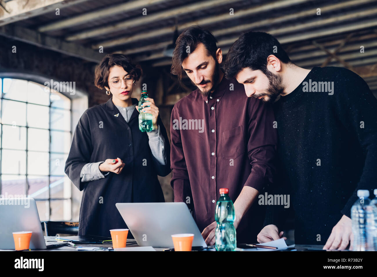 Designer showing presentation to colleagues in studio Stock Photo - Alamy