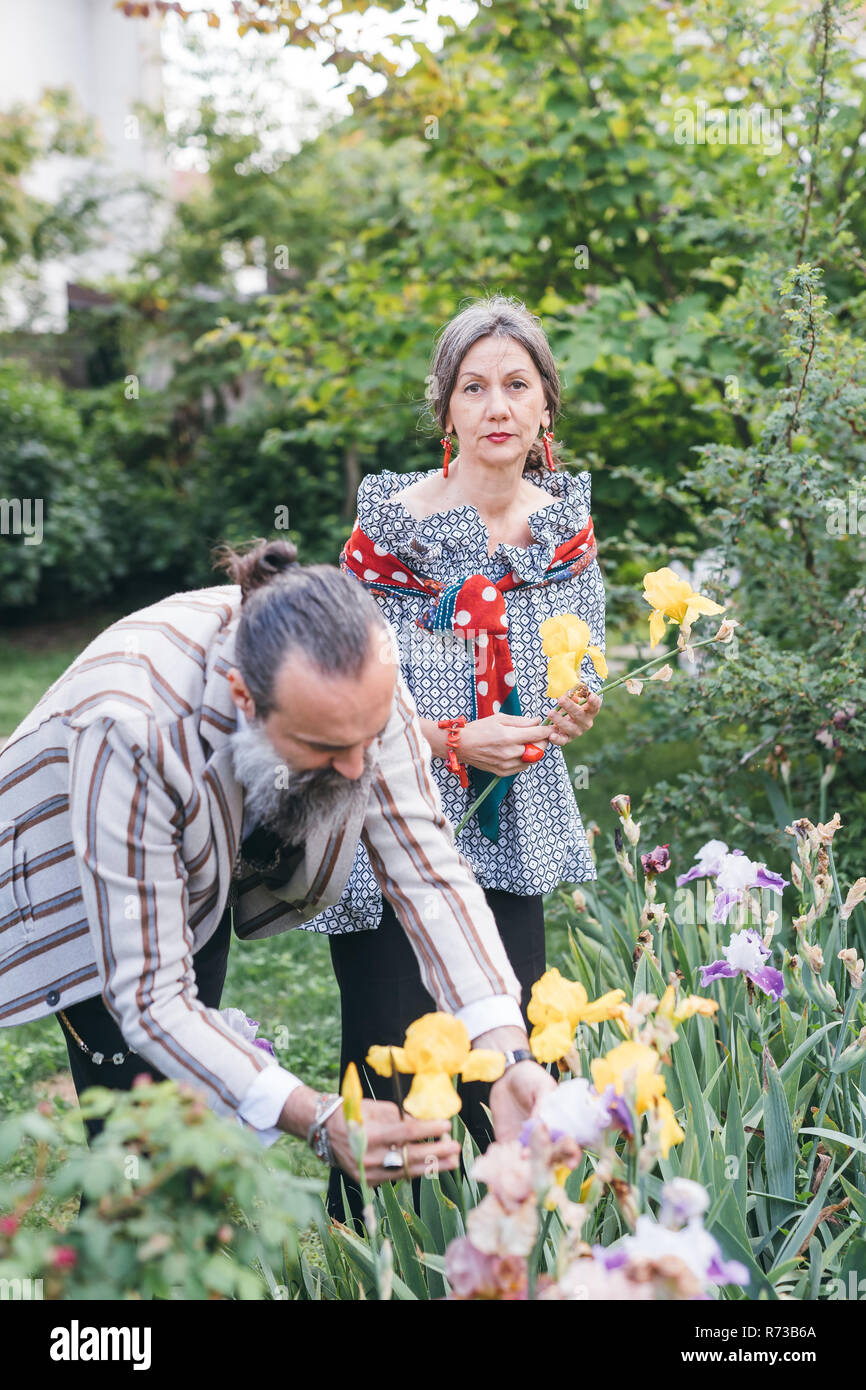 Couple picking flowers from garden Stock Photo - Alamy