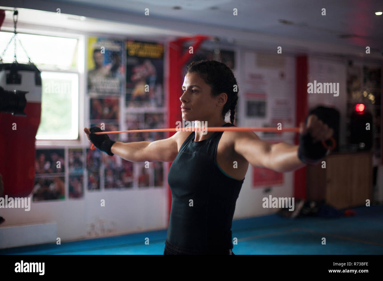 Female boxer doing stretching exercise in gym Stock Photo - Alamy