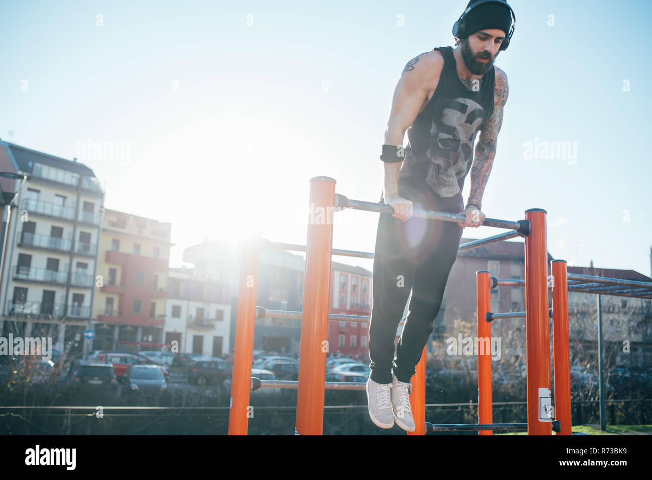 Man using push up bar in outdoor gym Stock Photo - Alamy