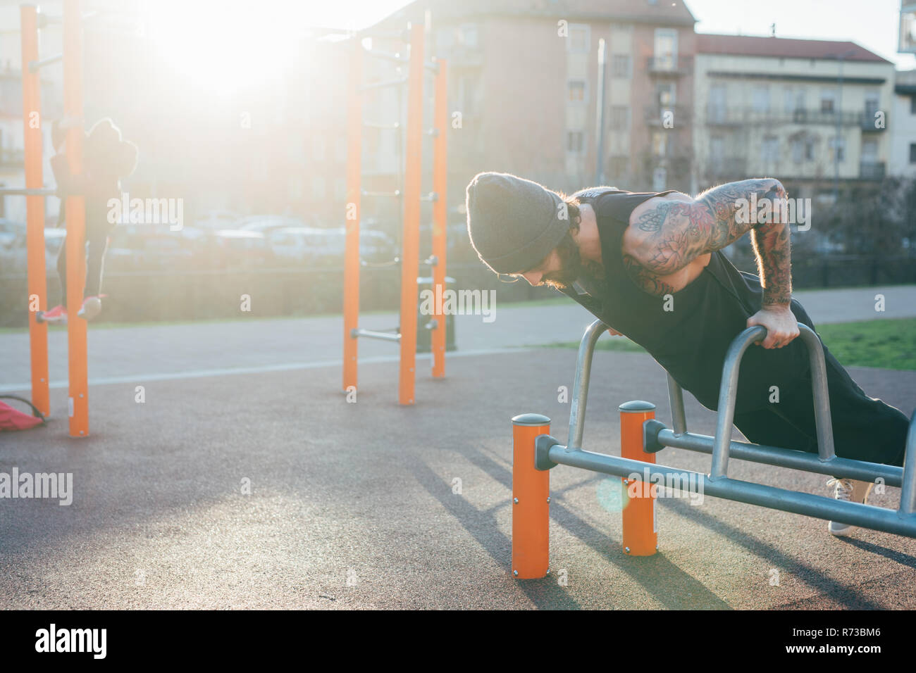 Man using push up bar in outdoor gym Stock Photo - Alamy