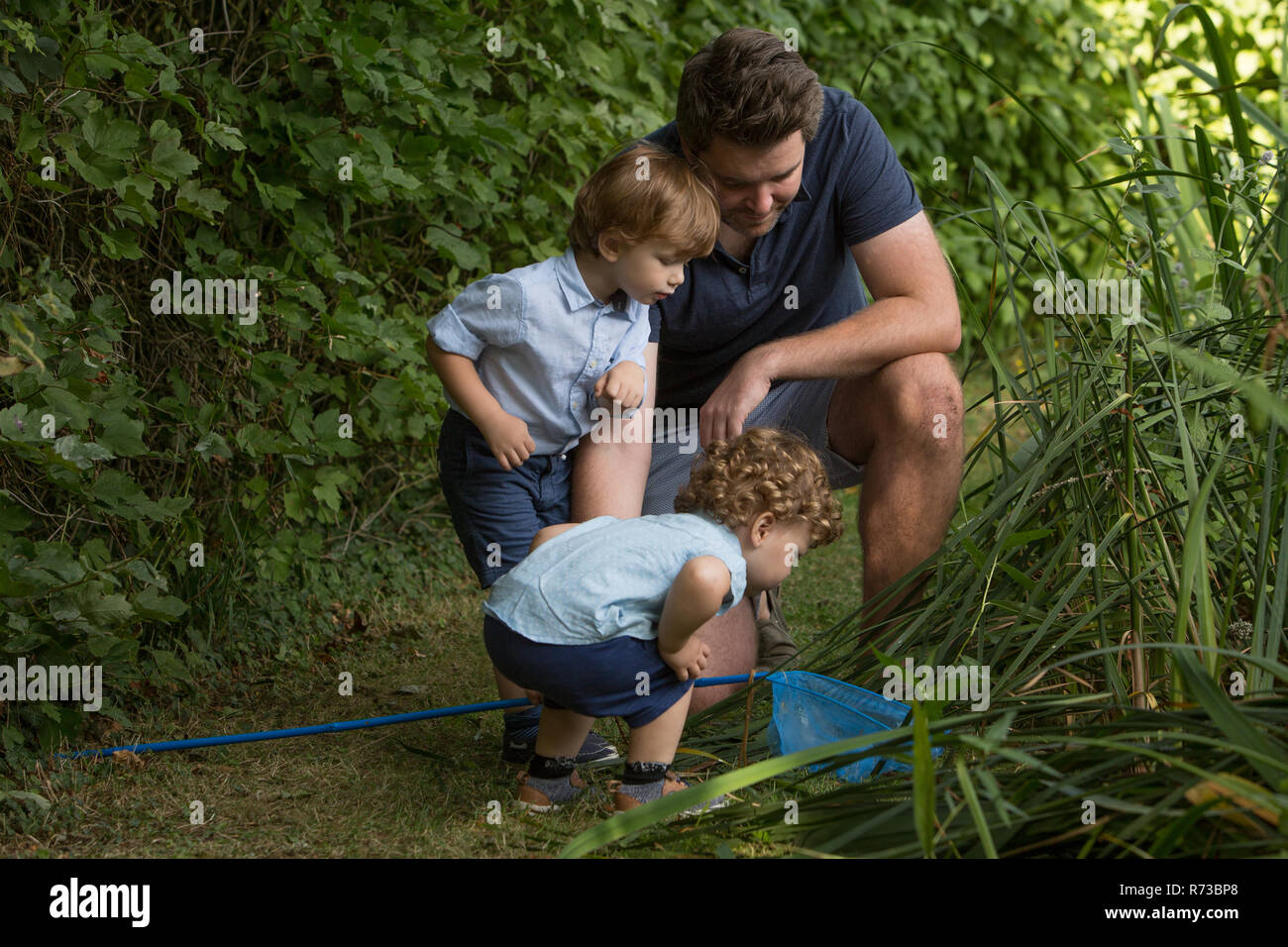 Child kneeling by a pond hi-res stock photography and images - Alamy