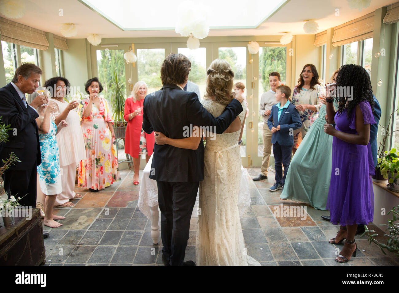 Wedding guests toasting to newlyweds at reception Stock Photo - Alamy