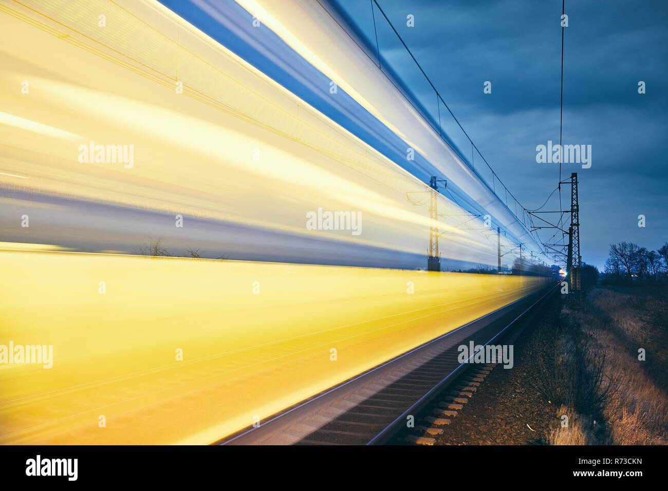Railroad track at night. Light trails of passenger train Stock Photo ...