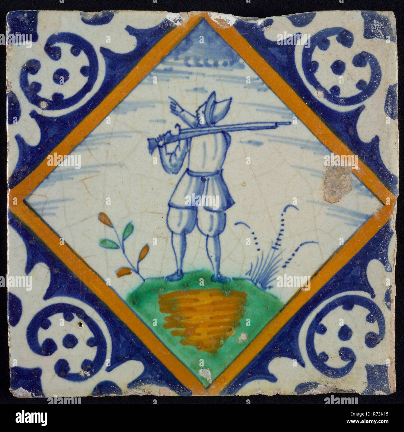 White tile with blue soldier with rifle on hill in yellow and green in ...