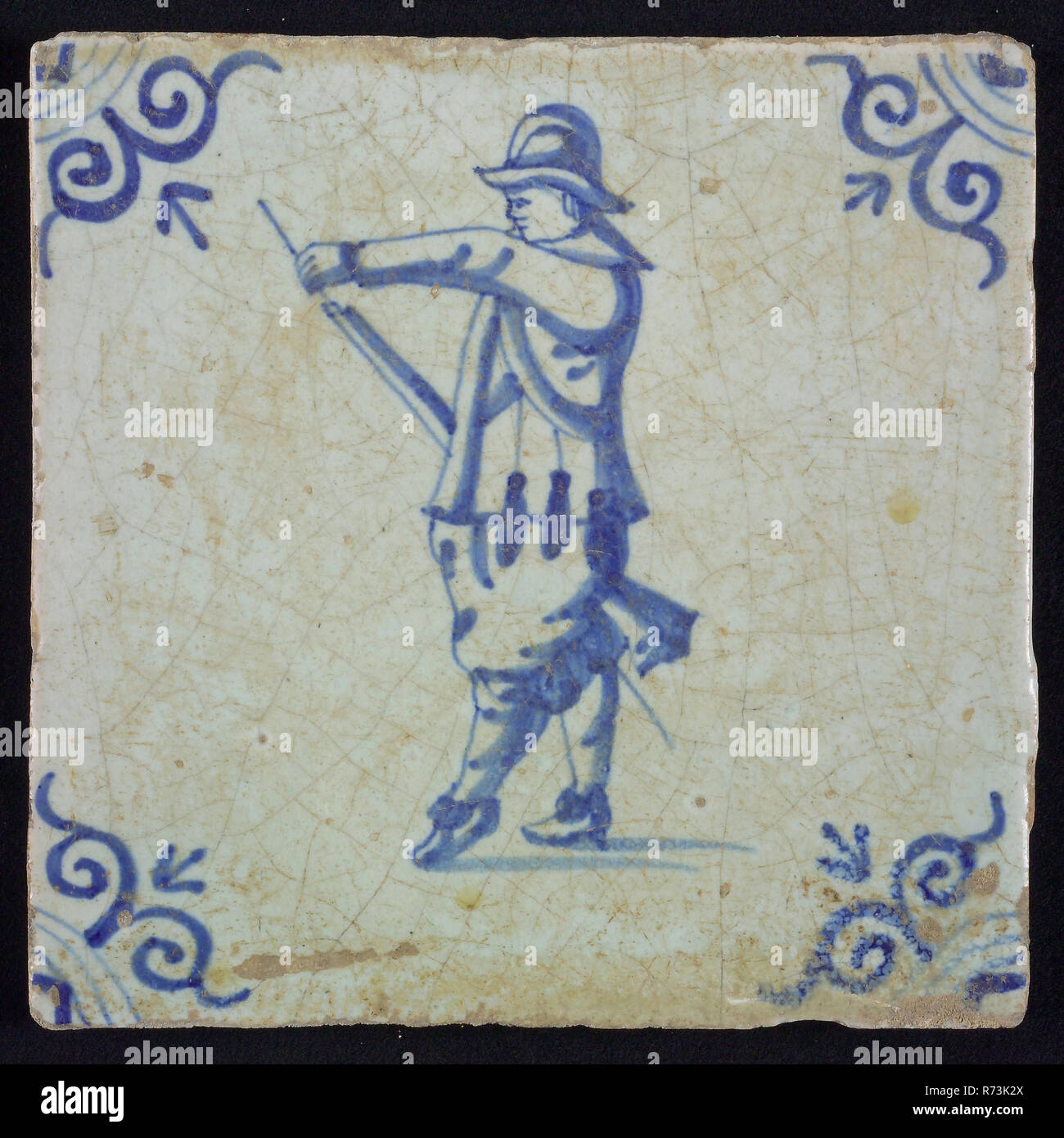 White tile with blue warrior with helmet, loading his rifle; corner ...