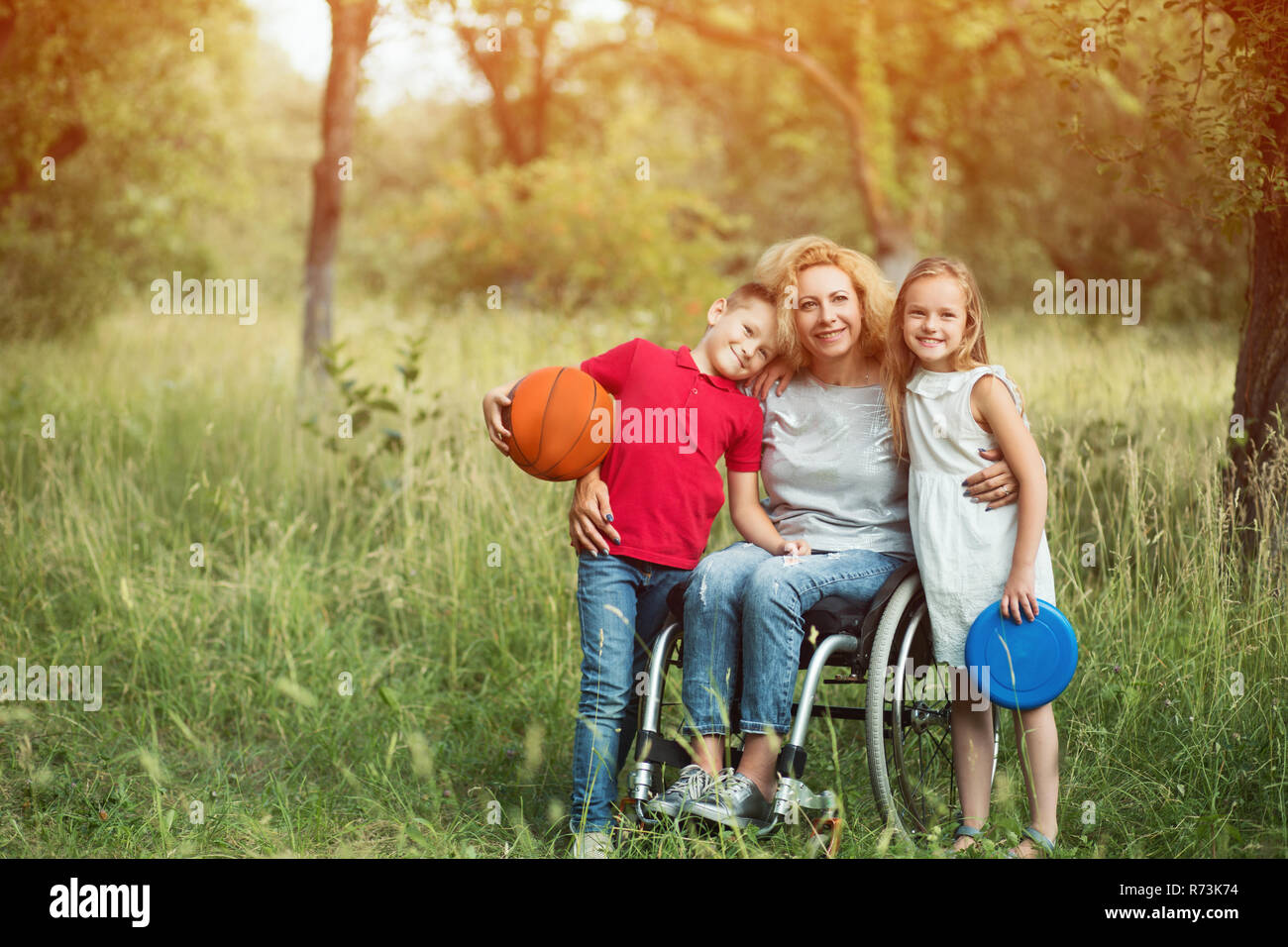 Family portrait. Woman in a wheelchair with her family outdoors Stock ...