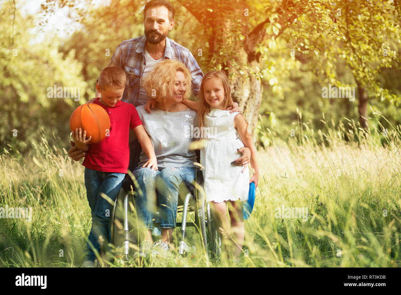 Family portrait. Woman in a wheelchair with her family outdoors Stock ...