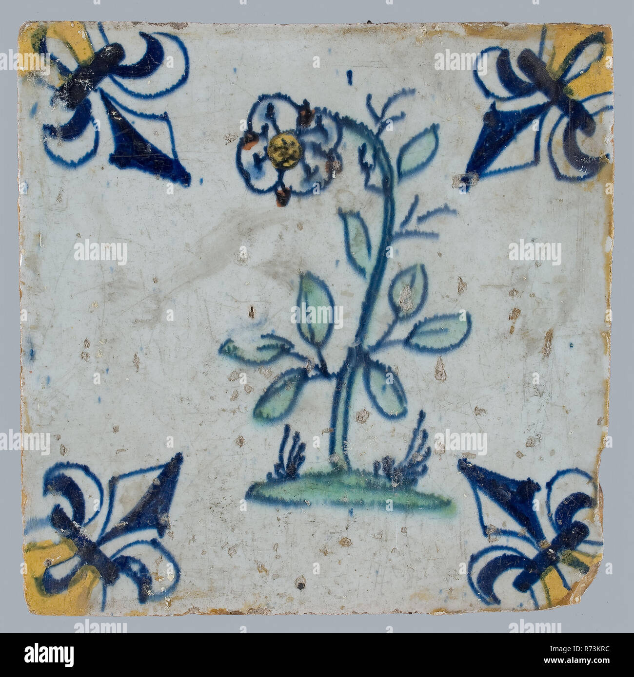Tile, flower on ground in yellow, brown, green and blue on white ...