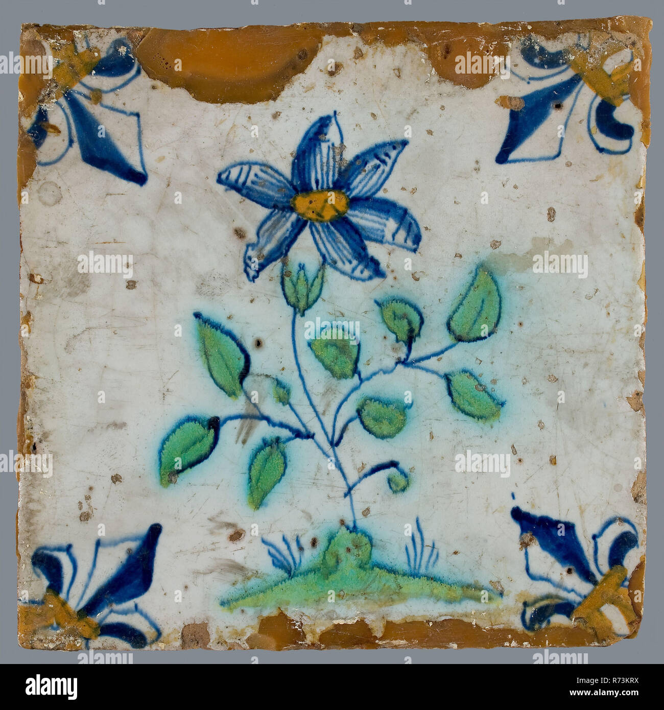 Tile, flower on ground in orange, green and blue on white, corner ...
