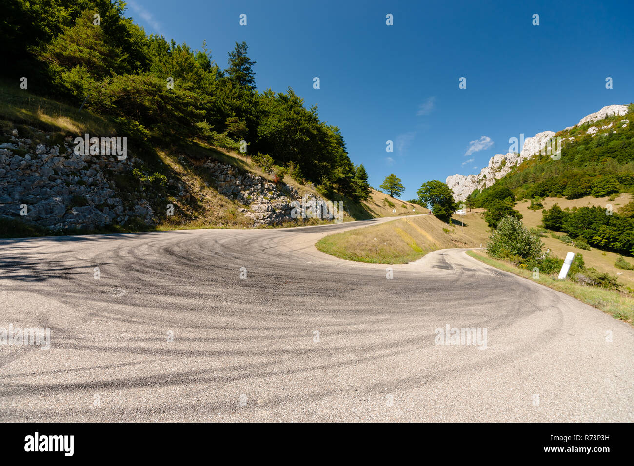 Winding mountain roads with sharp turns and asphalt along steep ...