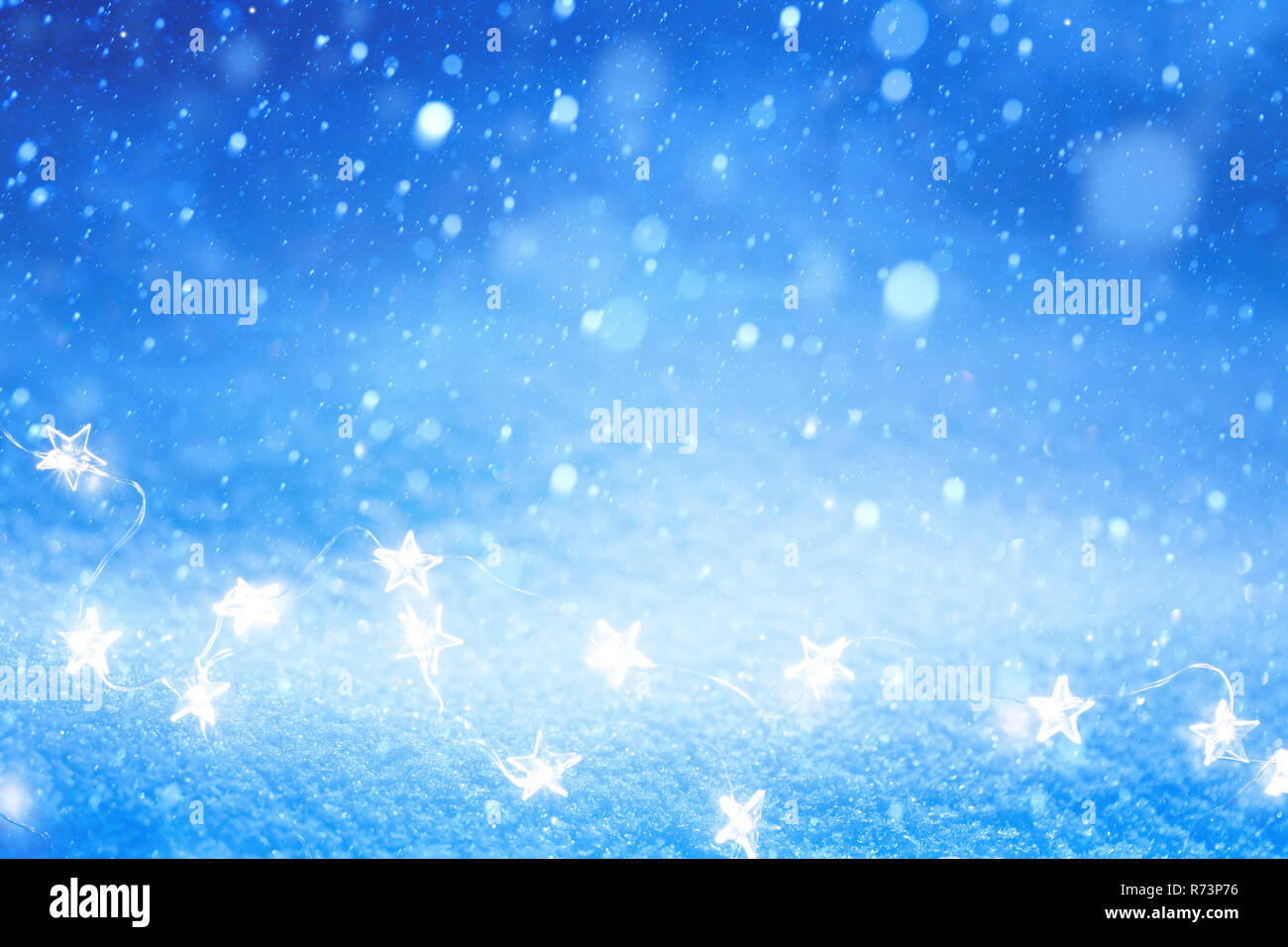 Christmas Light on blue snow background Stock Photo - Alamy