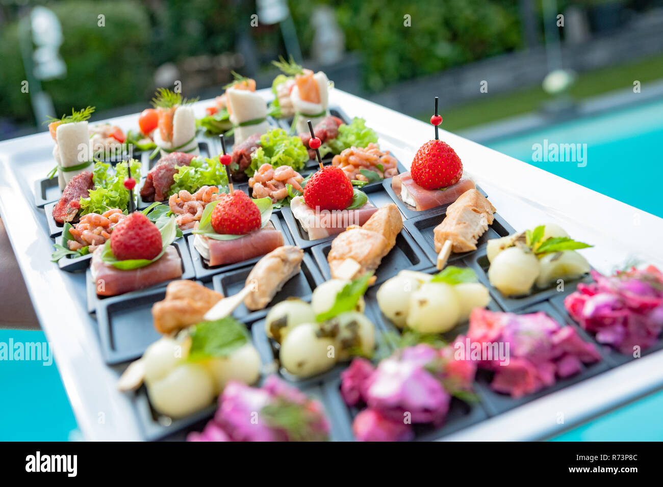 Small dishes on a plateau with a variety of fruits, vegetables, fish ...