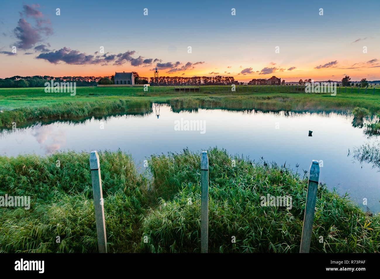 An old harbor head in the dry fallen polder of the Netherlands during ...