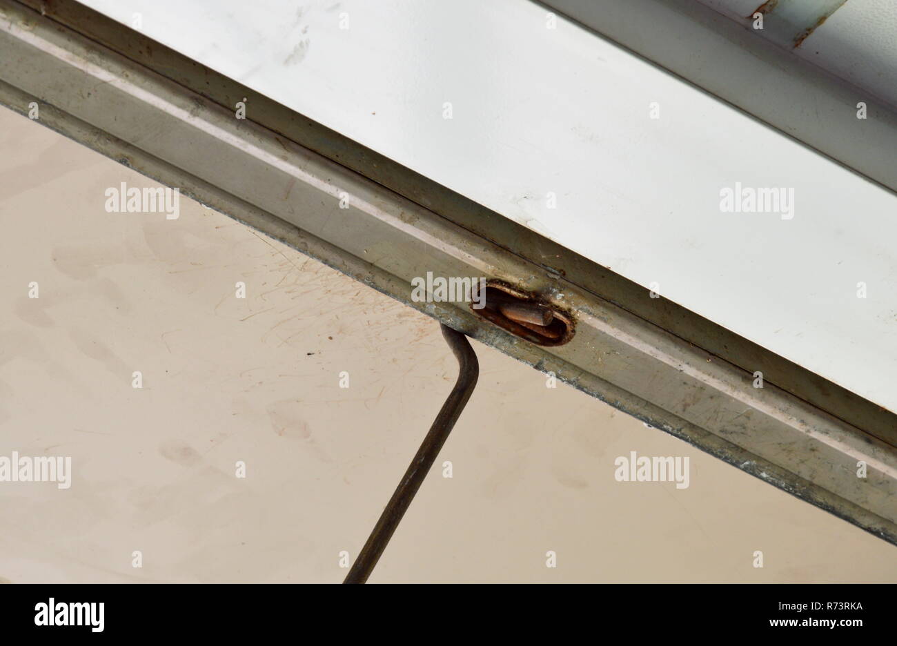 long iron hook pull the door shutter down Stock Photo - Alamy