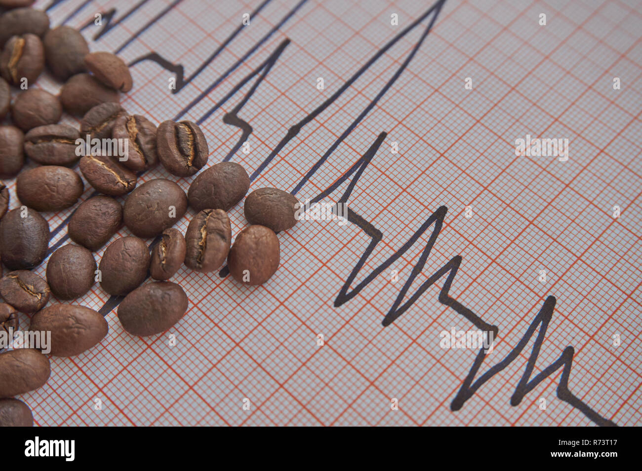 Loose roasted coffee beans on an ECG tracing Stock Photo - Alamy