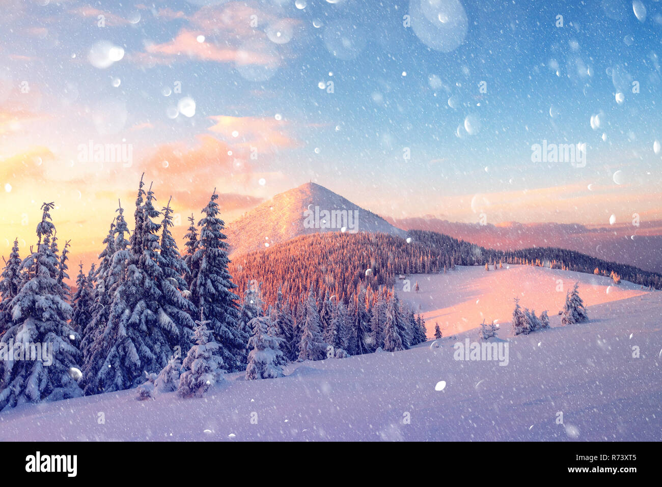 Fantastic orange winter landscape in snowy mountains glowing by sunlight. Dramatic wintry scene ...