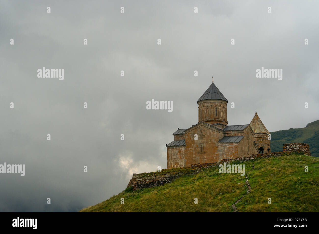 The Gergeti Trinity Church high on the hills over looking the village ...