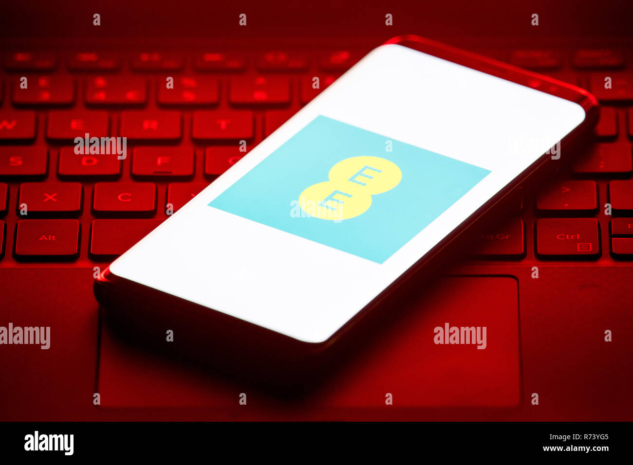 The logo of mobile phone network EE is displayed on the screen of a ...