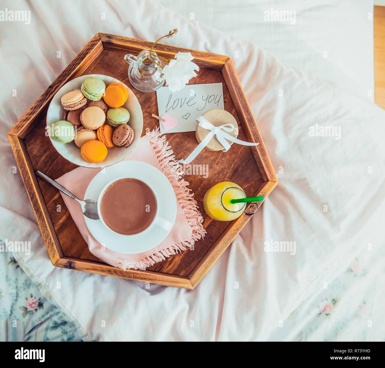 Breakfast in bed with i love you text on a note. Cup of coffee, juice ...