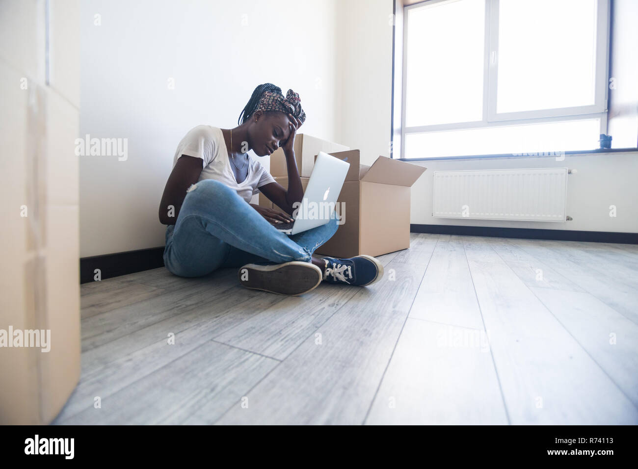 Sad woman packing boxes hi-res stock photography and images - Alamy
