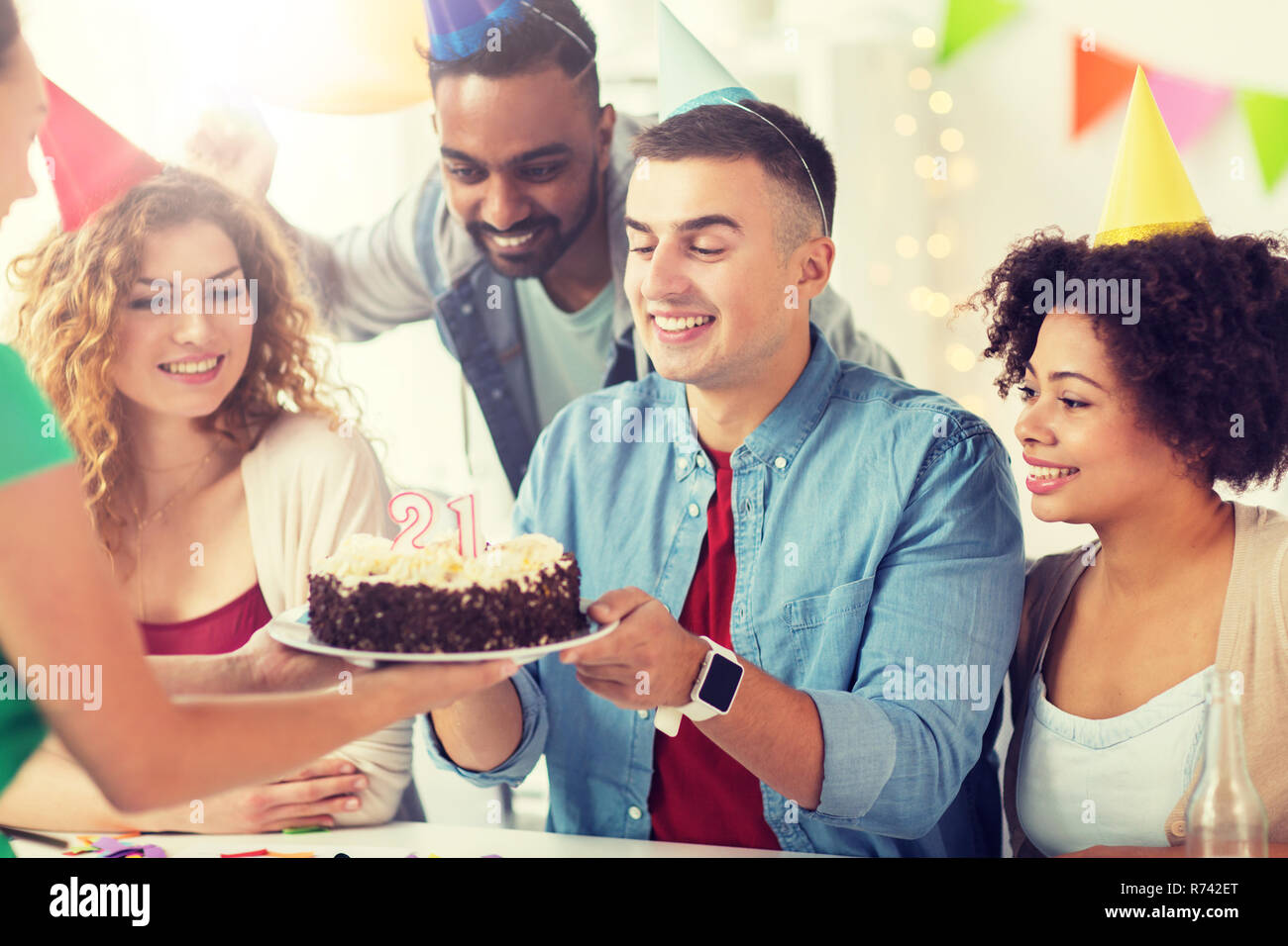 team greeting colleague at office birthday party Stock Photo - Alamy