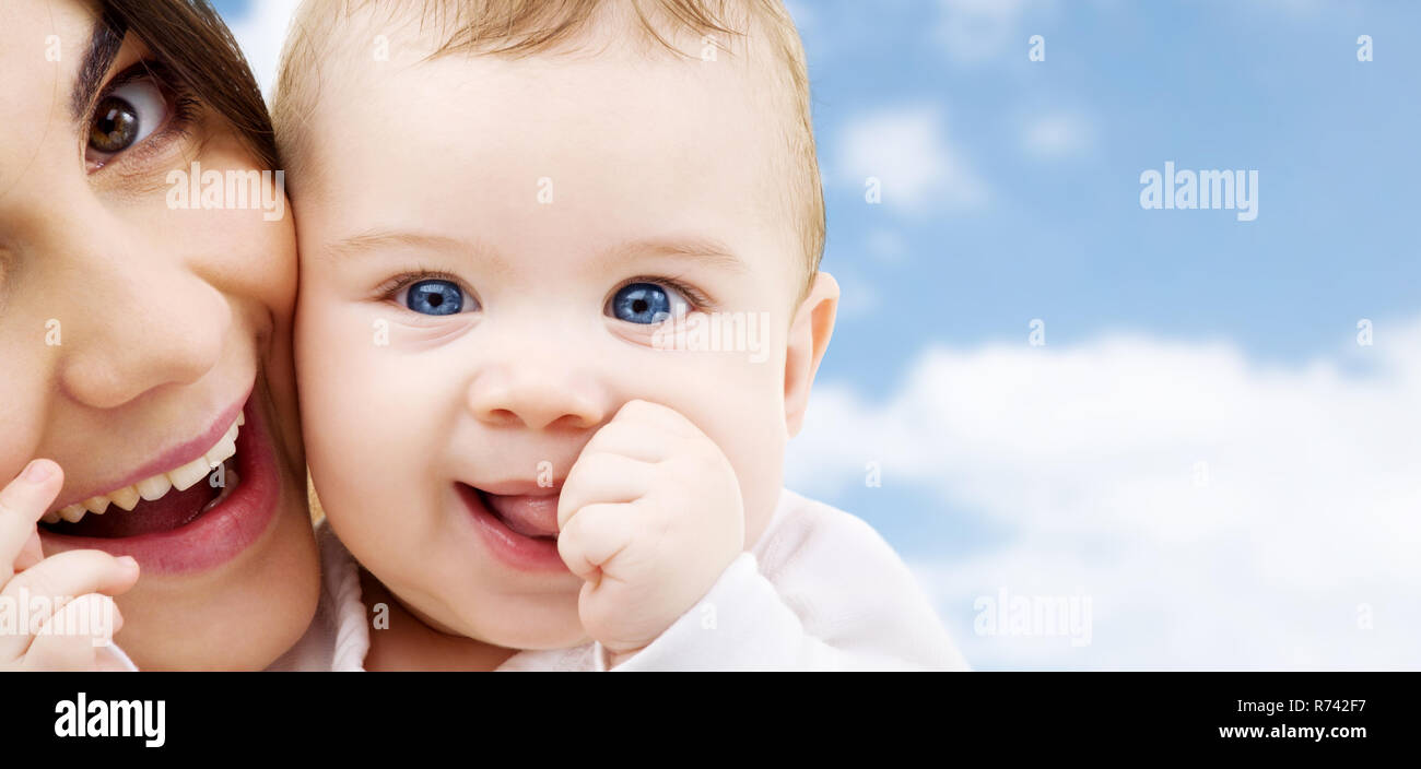 mother with baby over sky background Stock Photo - Alamy